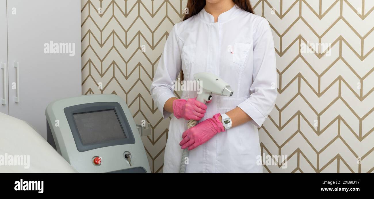Female dermatologist posing with diode laser hair removal tool. Female ...