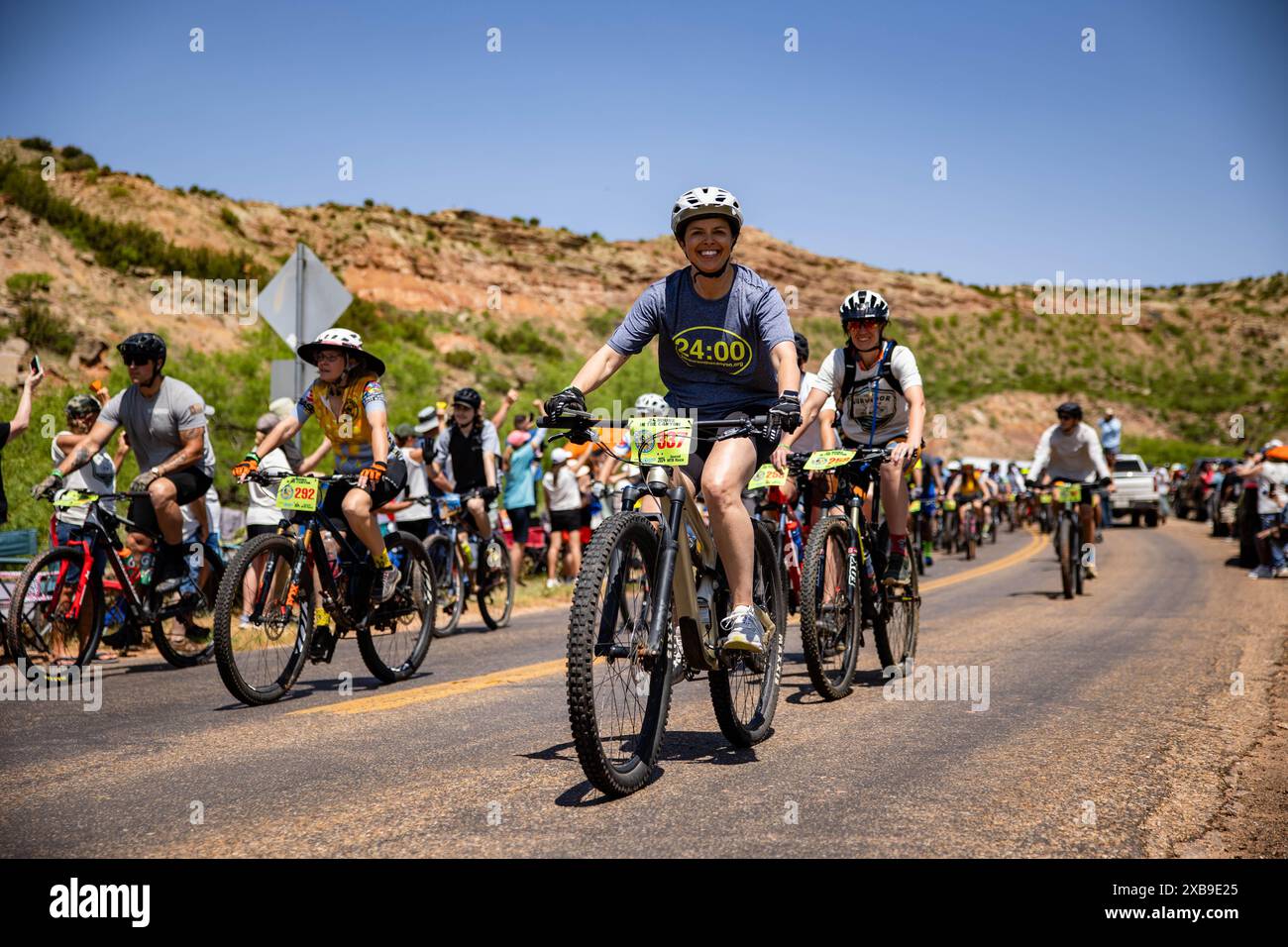 The cyclists participating in a mountain bike race with spectators ...