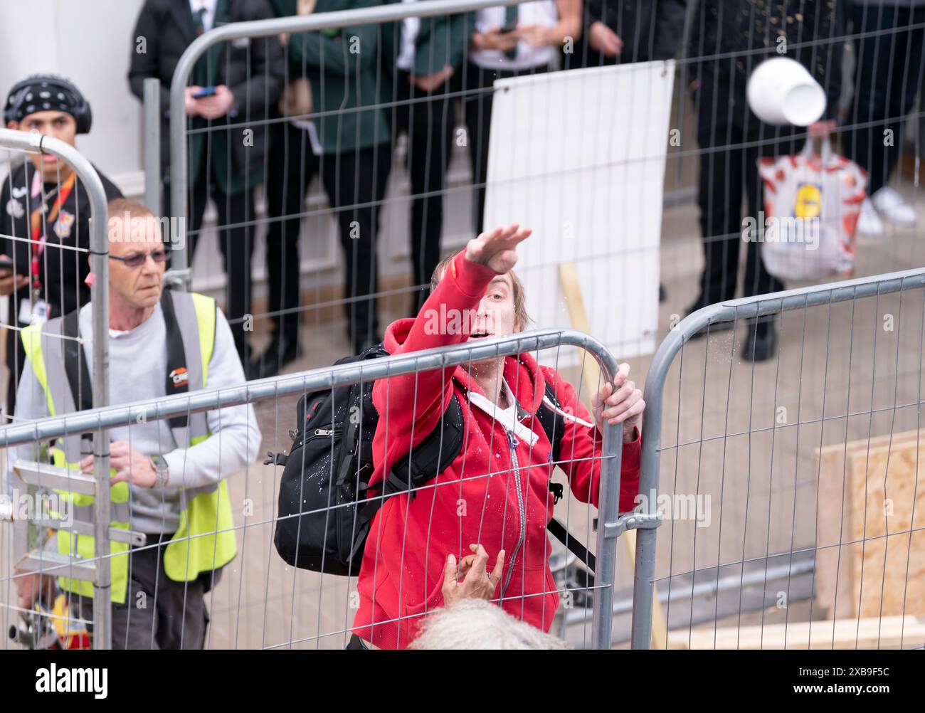 A person throws a cup towards Reform UK leader Nigel Farage on the ...