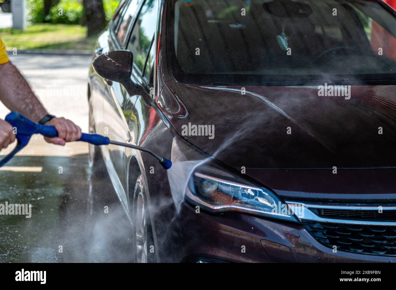 Close-up car washing with high pressure car washer spray gun Stock ...