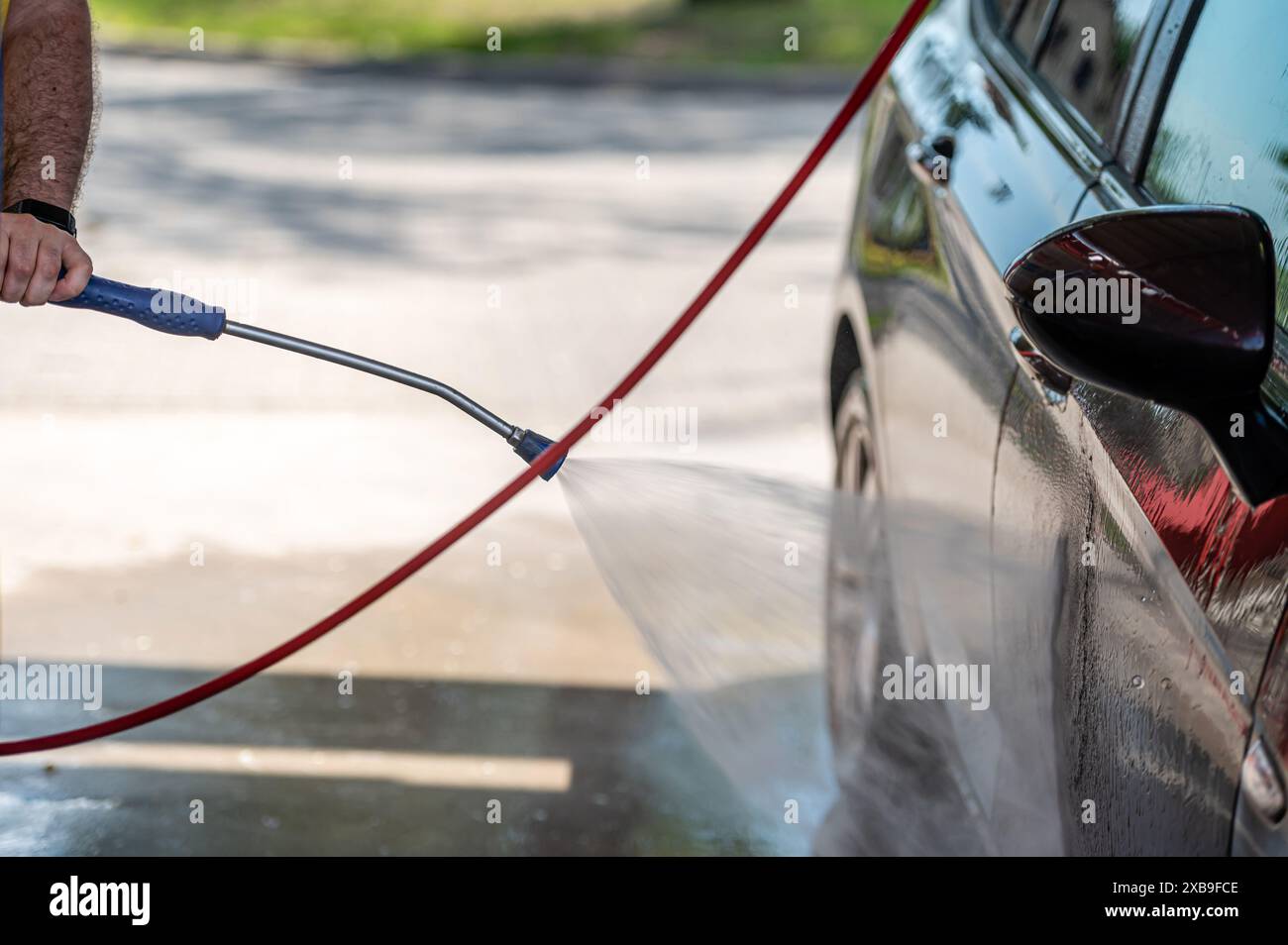 Close-up car washing with high pressure car washer spray gun Stock ...