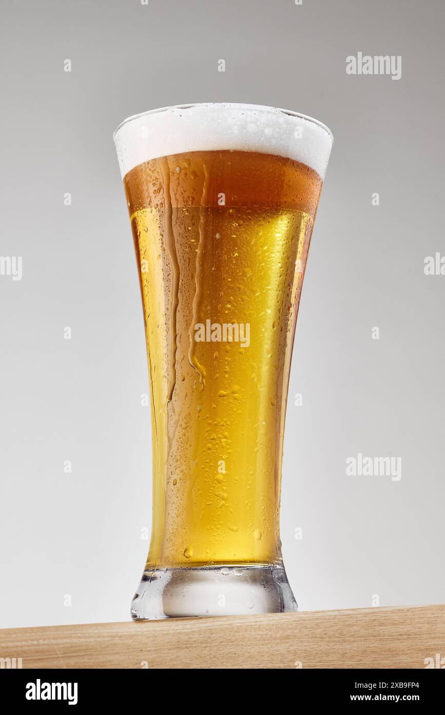 Beer glass with craft, cold, golden, sparkled liquid with frothy, thick ...