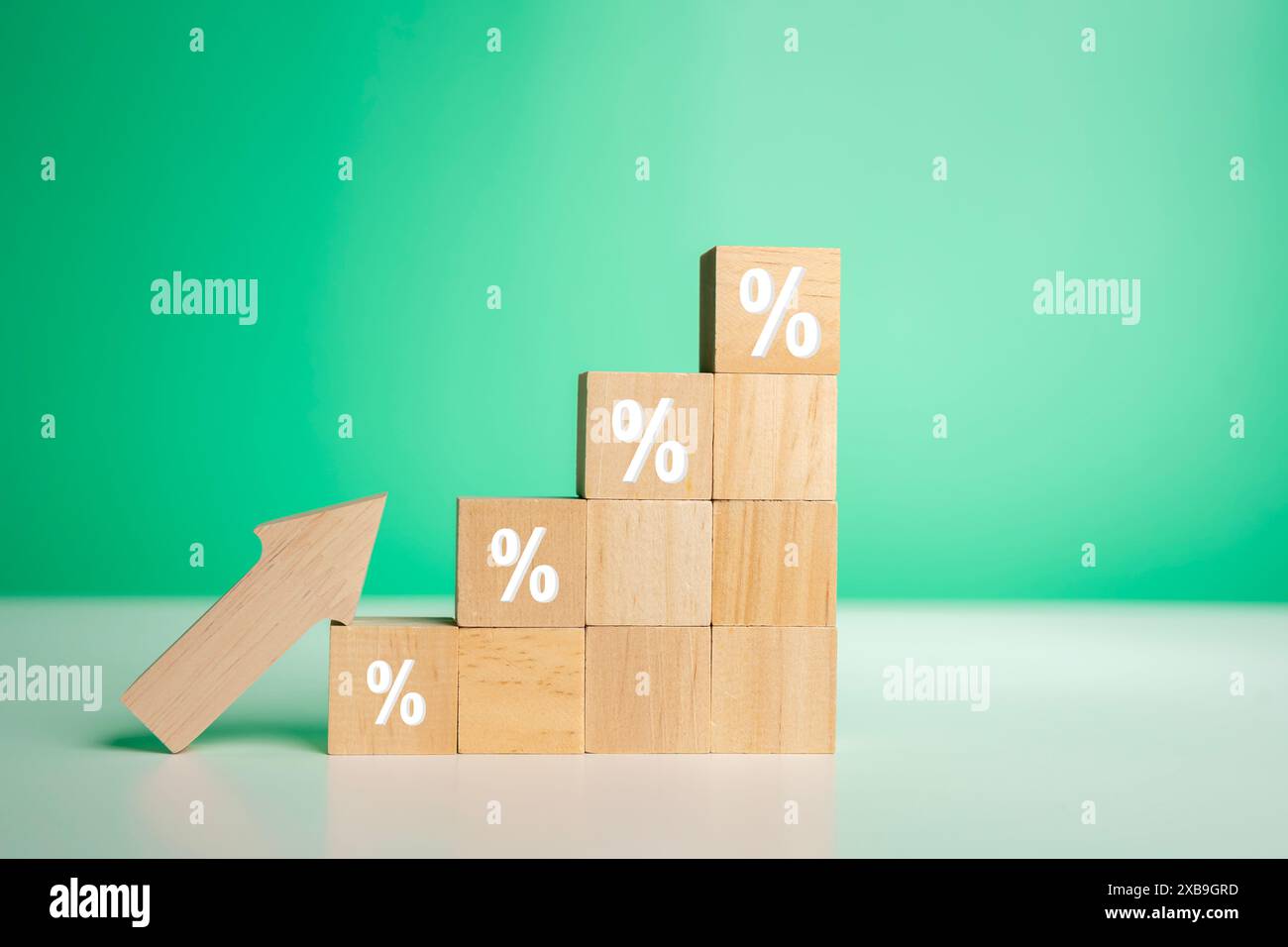 Wooden blocks with percentage sign and arrow up, financial growth ...