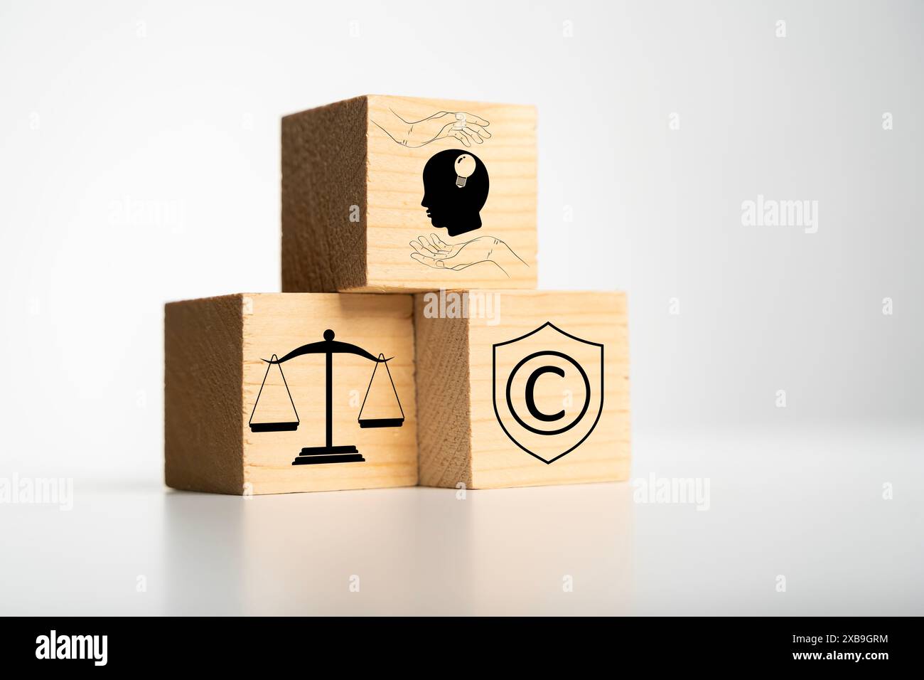 Wooden blocks with symbol of intellectual property concept on white ...
