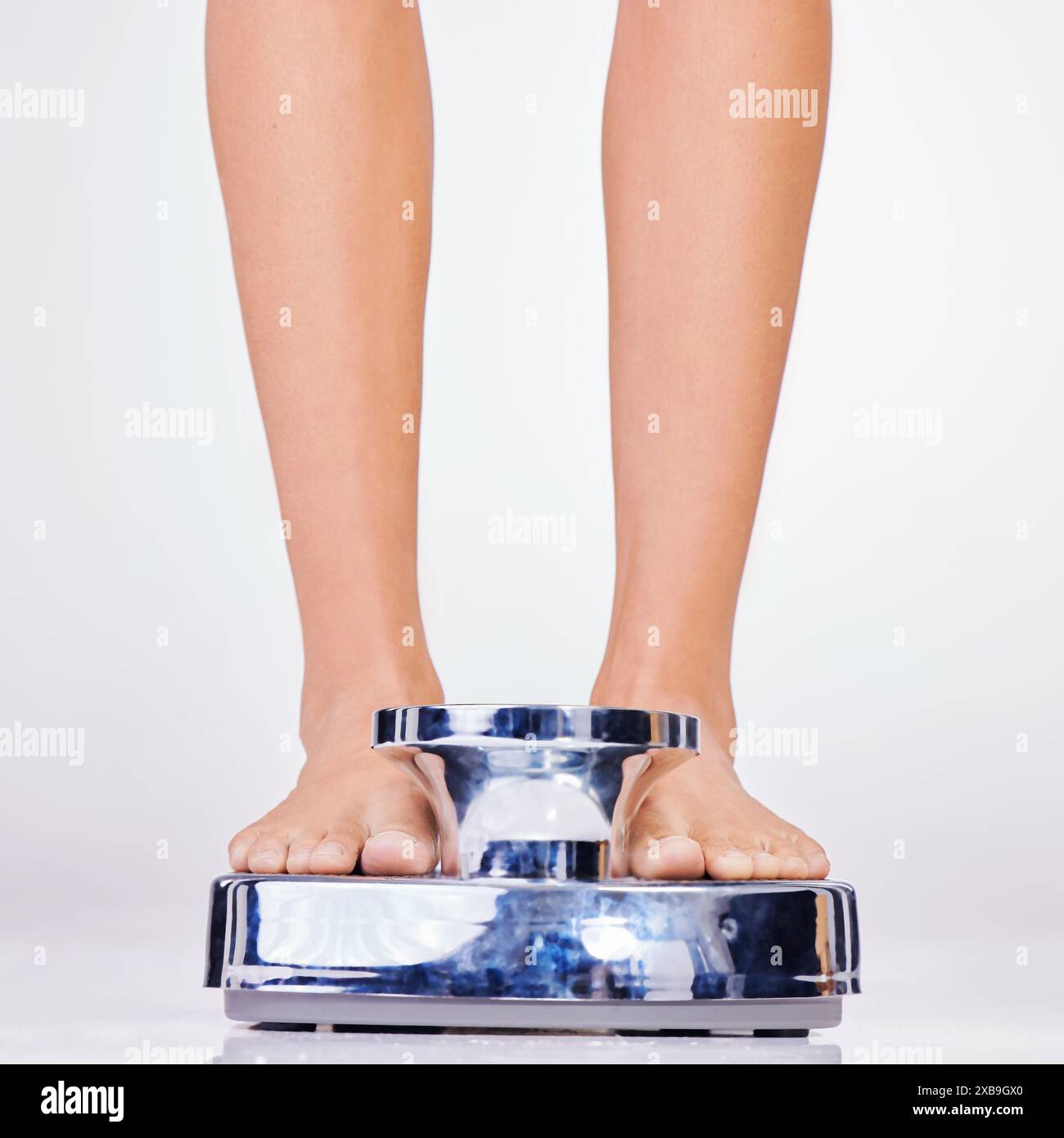 Feet, scale and weight loss in studio white background for wellness ...