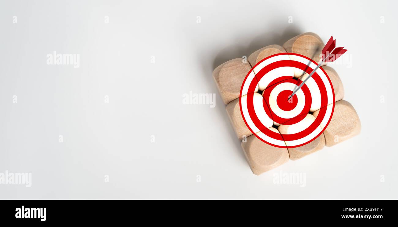 Big target icon of symbol on wooden cube blocks stack isolated on white background with copy ...