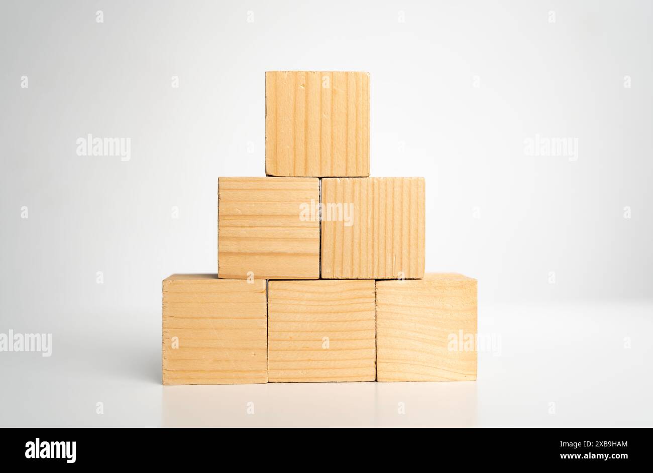 Empty blank wooden cube blocks build pyramid shape with the big one on ...