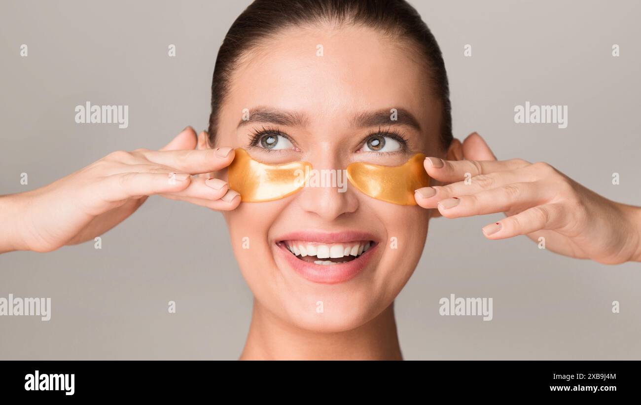 Woman Wearing Gold Eye Masks Patches and Smiling Stock Photo - Alamy