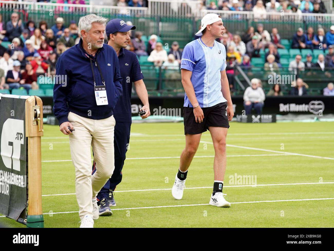 Dominic Stricker leaves the court for a medical time out during his ...