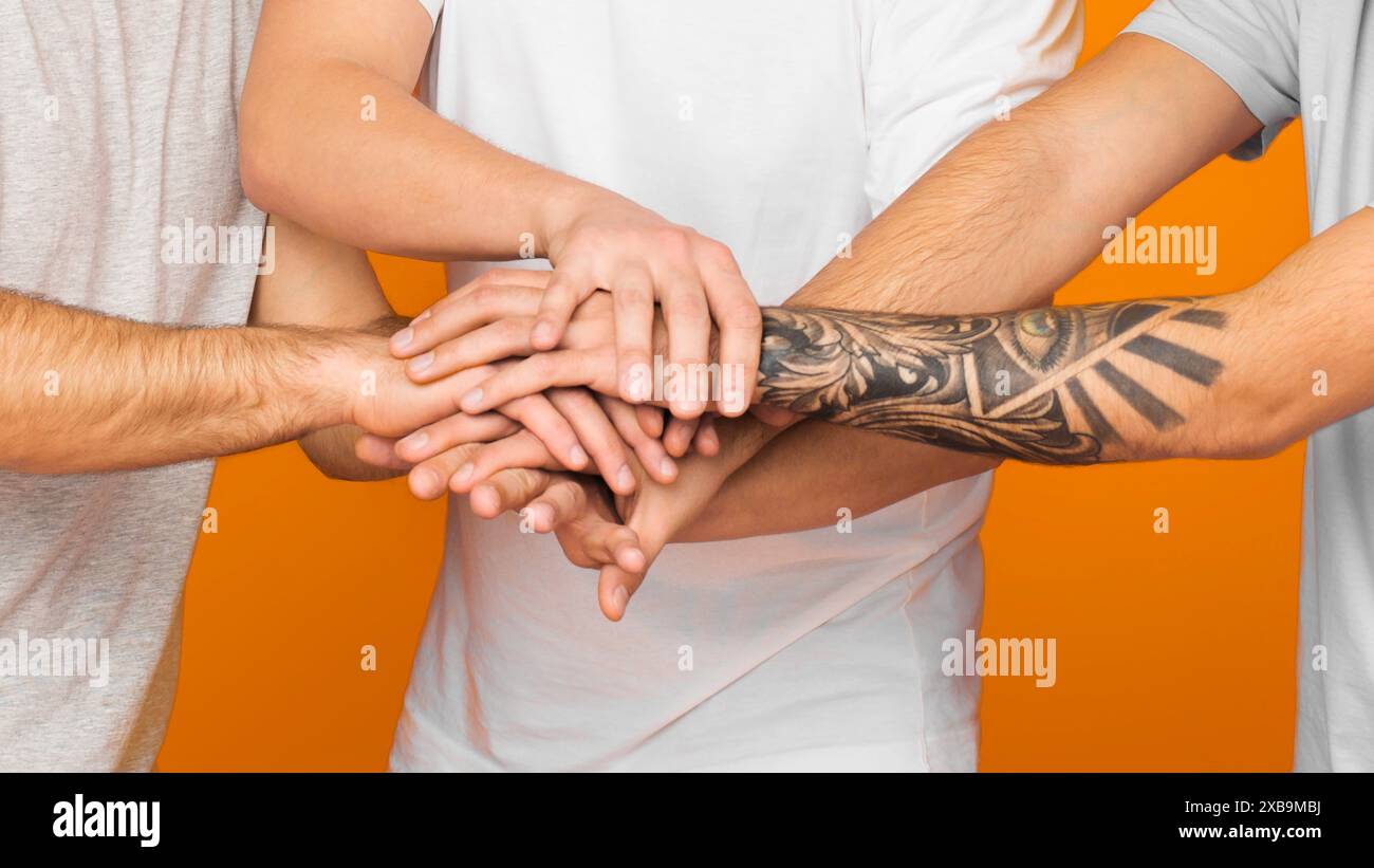 Men showing unity with hands together, cropped Stock Photo - Alamy
