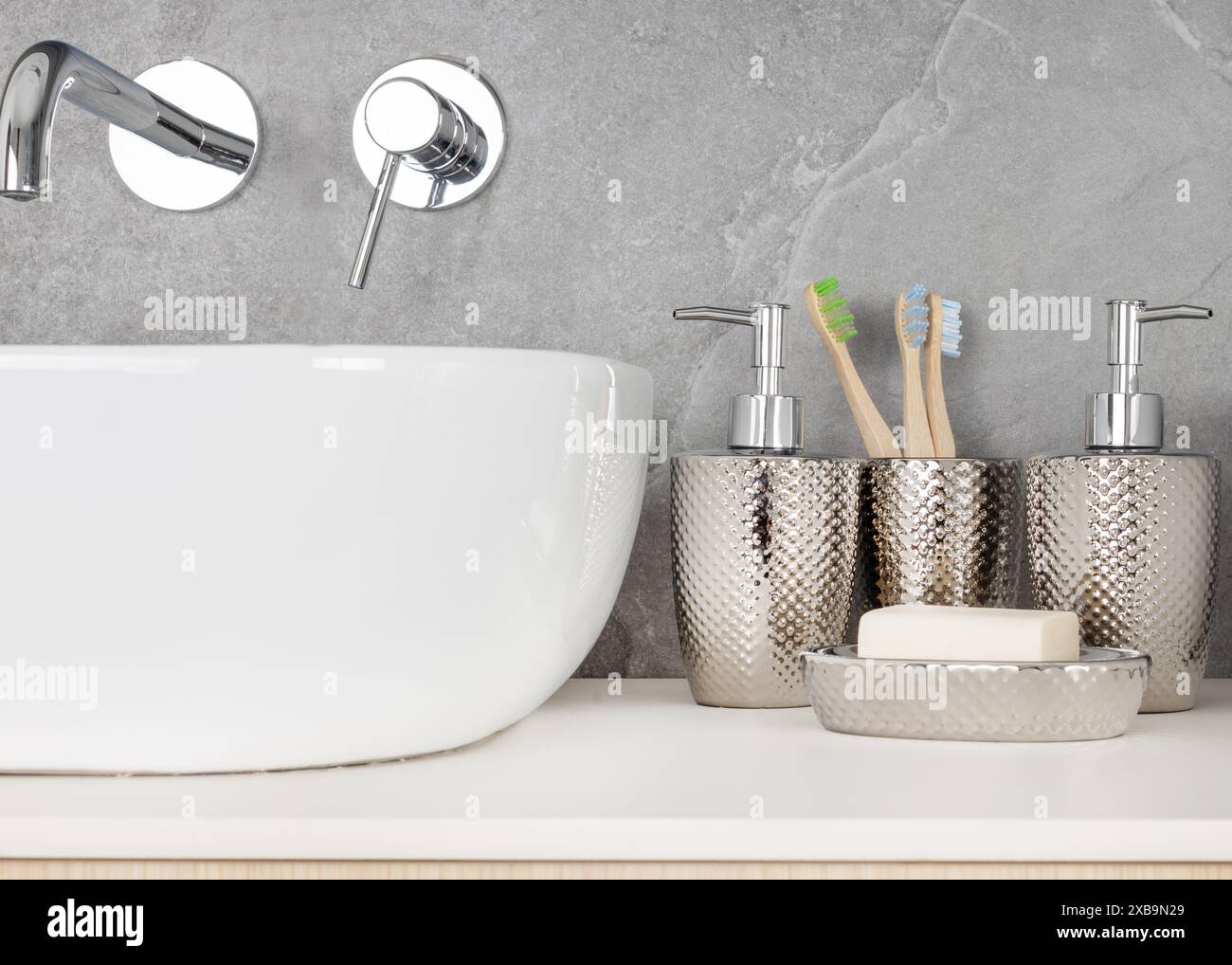 Toothbrushes in Holder Next to Bathroom Sink Stock Photo - Alamy
