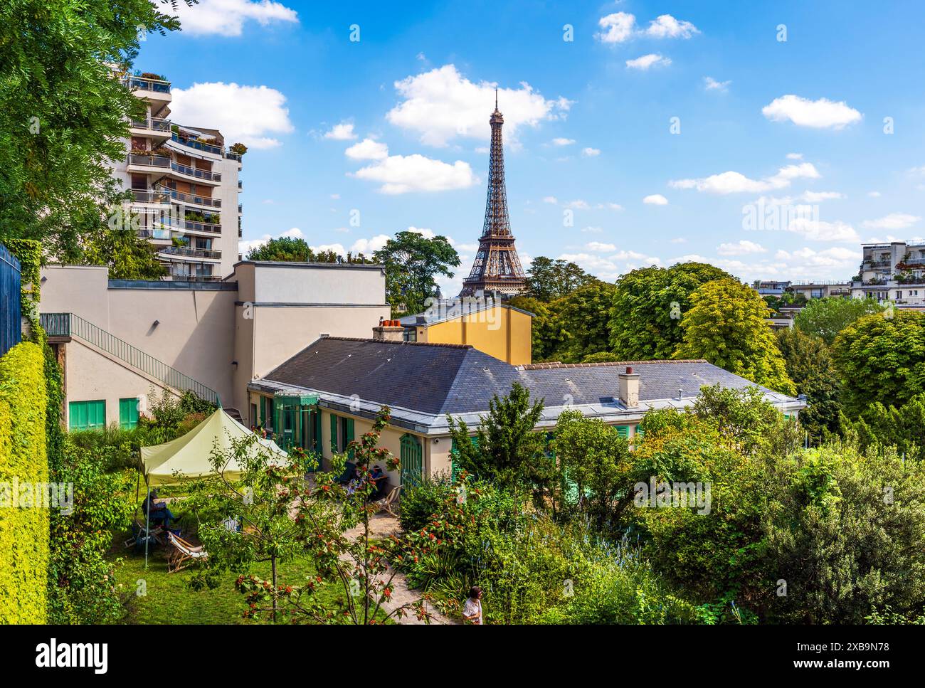 View of the Eiffel Tower and Maison de Balzac surrounded by vegetation ...