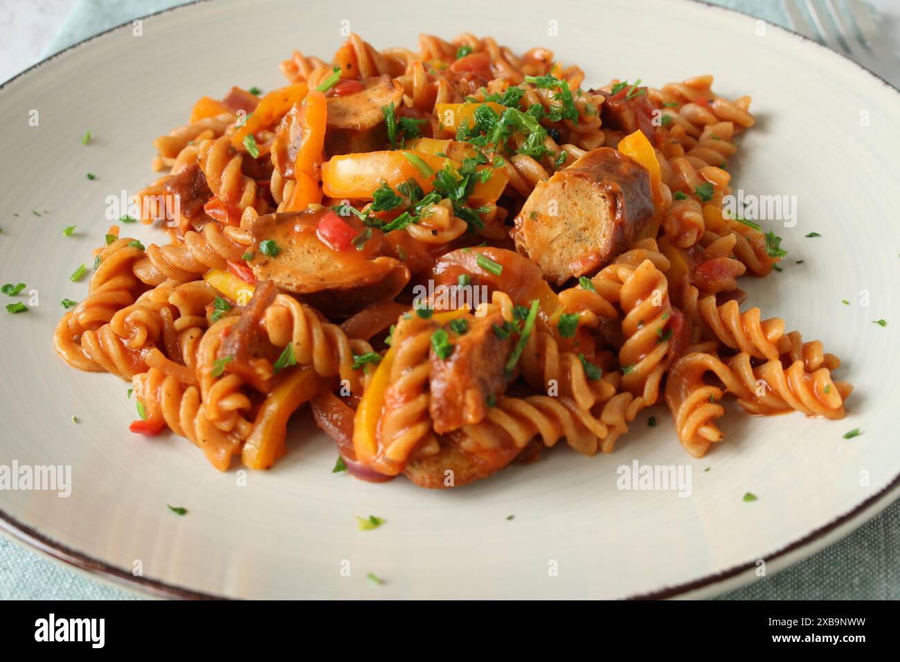 German Sausage Goulash with Whole Wheat Spiral Pasta Stock Photo - Alamy