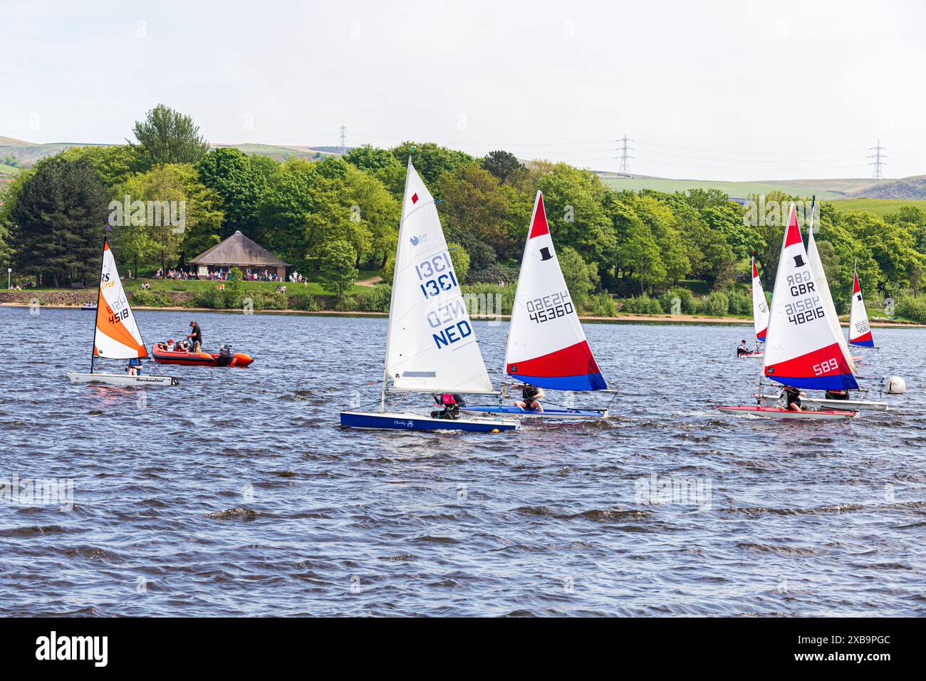 Young people racing sailing dinghies at Hollingworth Lake Sailing Club ...
