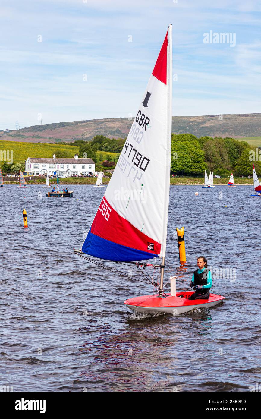 A teenage girl in a sailing dinghy at Hollingworth Lake Sailing Club ...