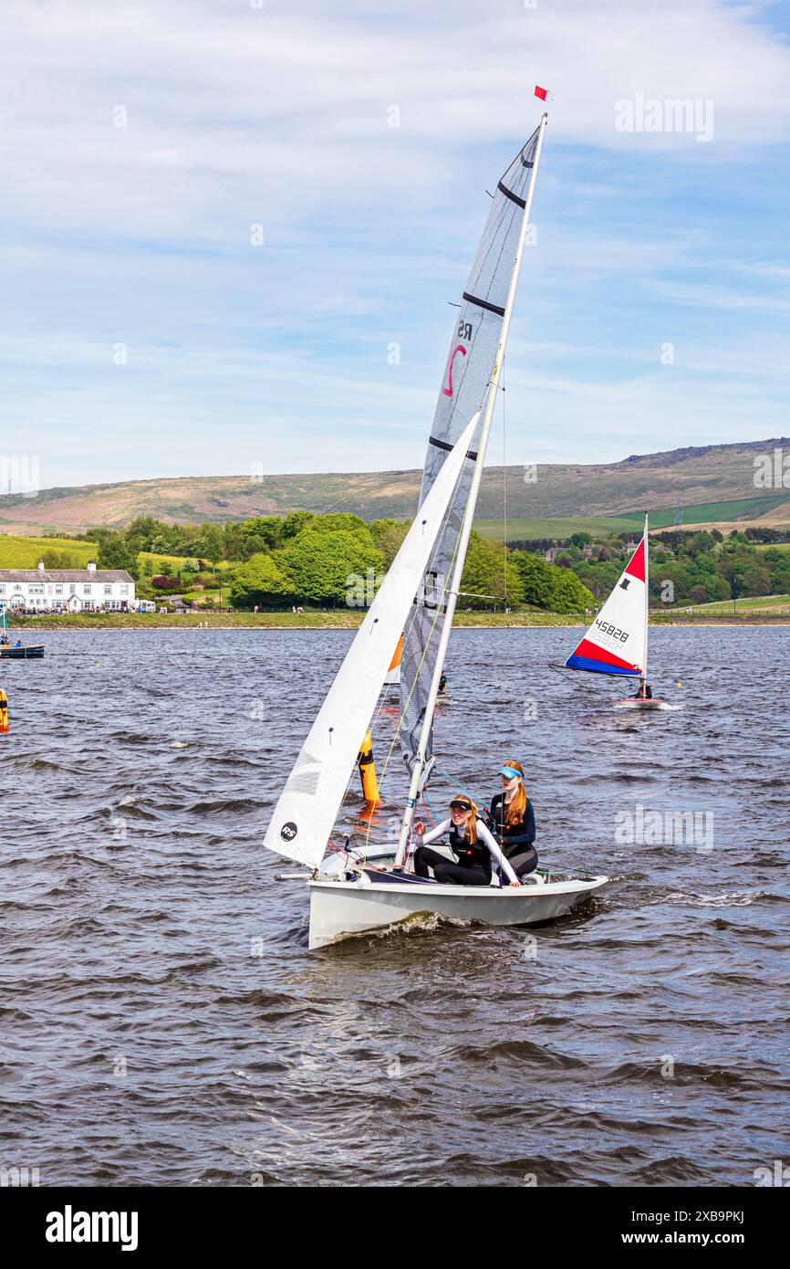Two teenage girls in a sailing dinghy at Hollingworth Lake Sailing Club ...