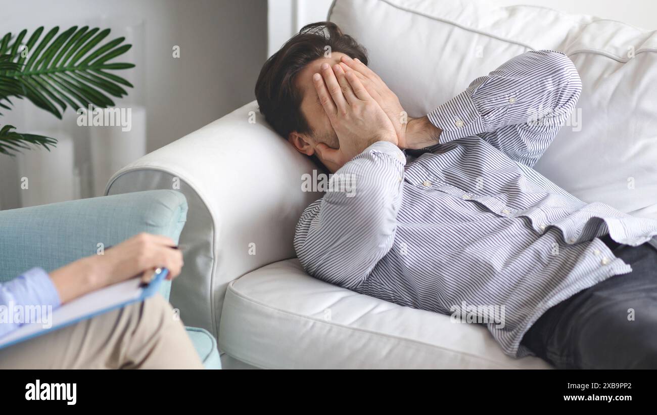 Man in Therapy Session Expressing Distress on a Couch Stock Photo - Alamy