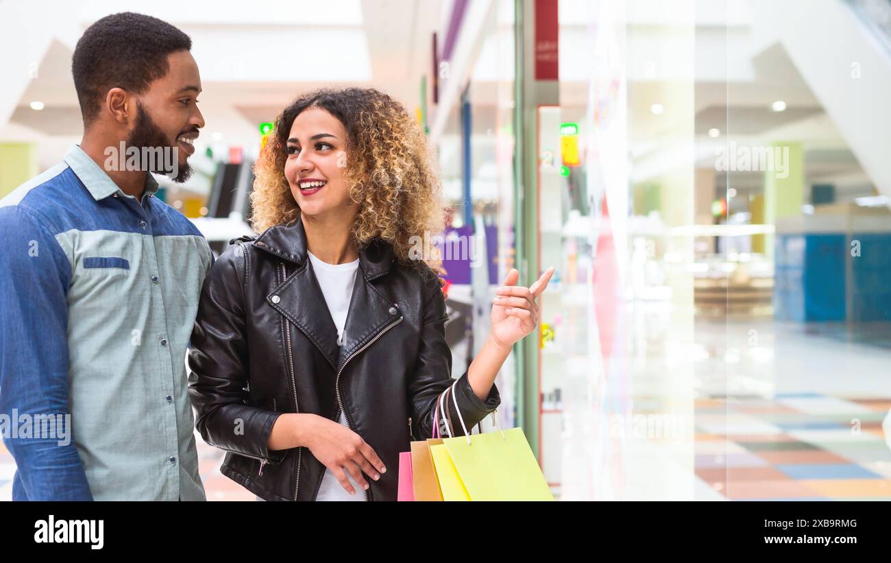 Young Black Man and Woman Shopping in a Mall Stock Photo - Alamy