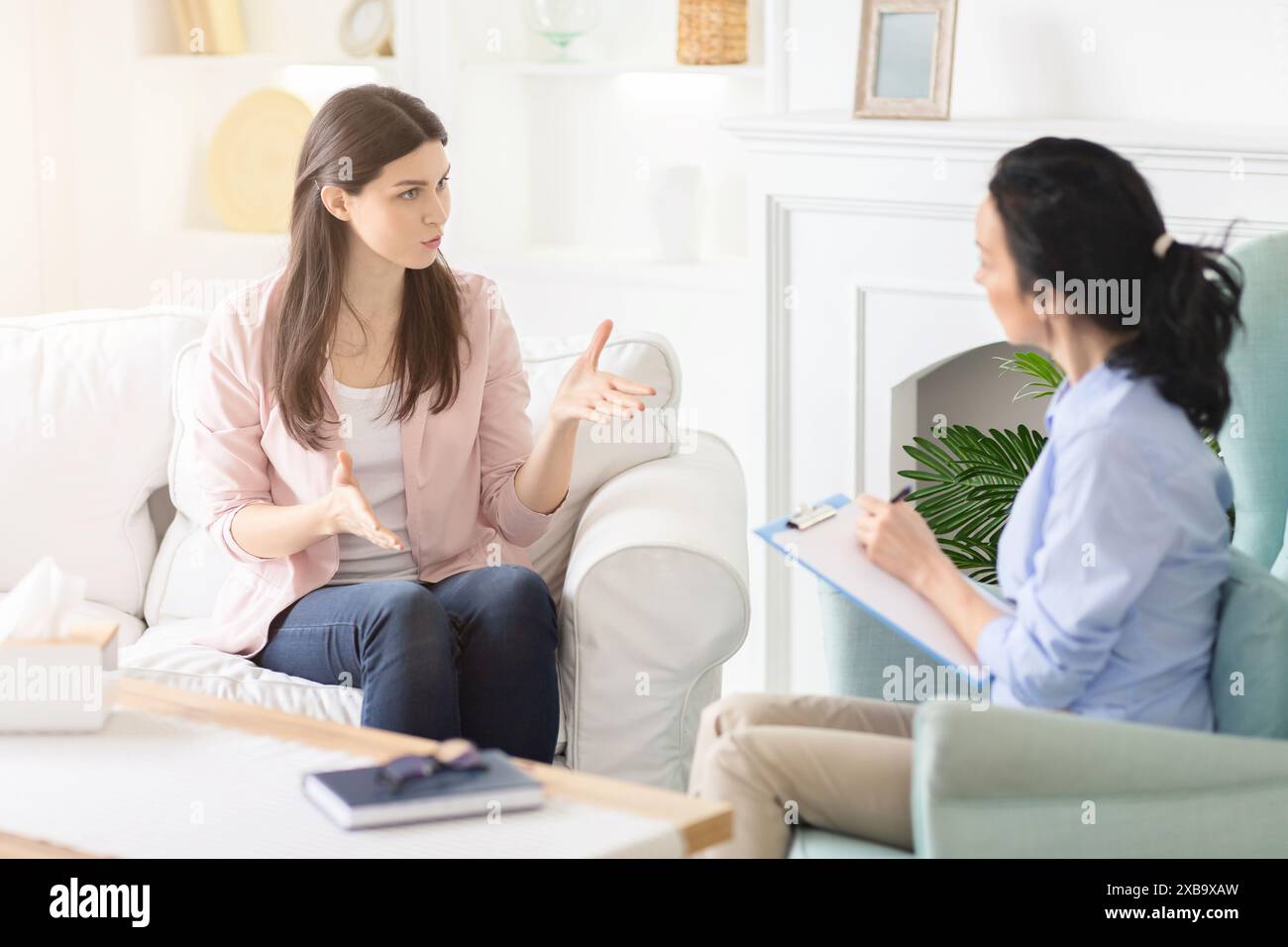 Two Women Engaged in Deep Conversation During Daytime Stock Photo - Alamy