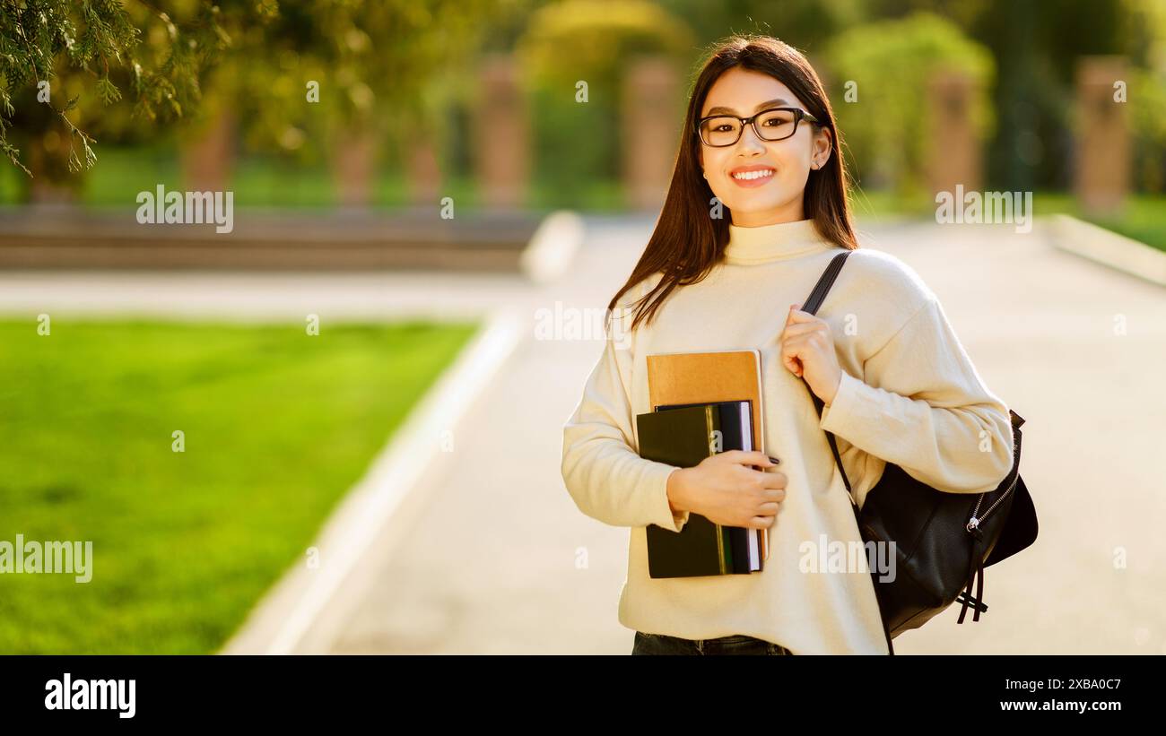 College Student Walking With Backpack and Books Stock Photo - Alamy