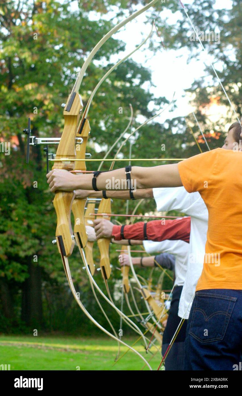 Archer with a bow and arrow aiming in the twilight Archer with bow and ...