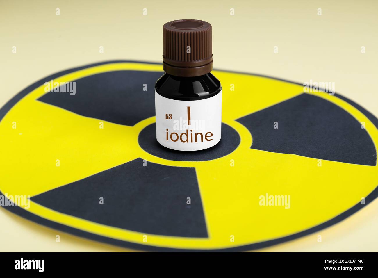 Bottle of medical iodine and radiation sign on beige background Stock ...