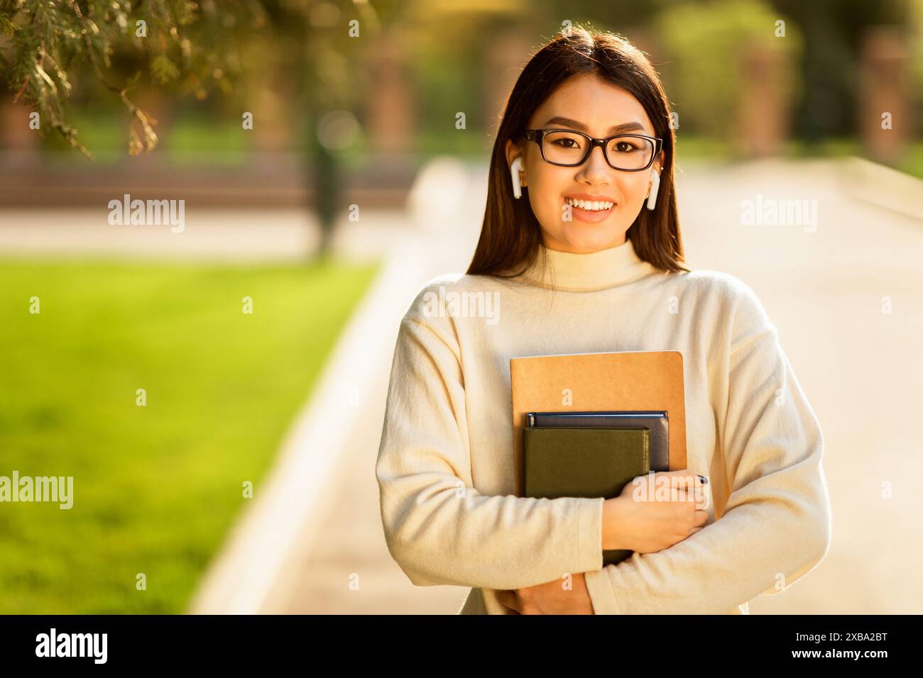 Happy asian student walking hi-res stock photography and images - Alamy