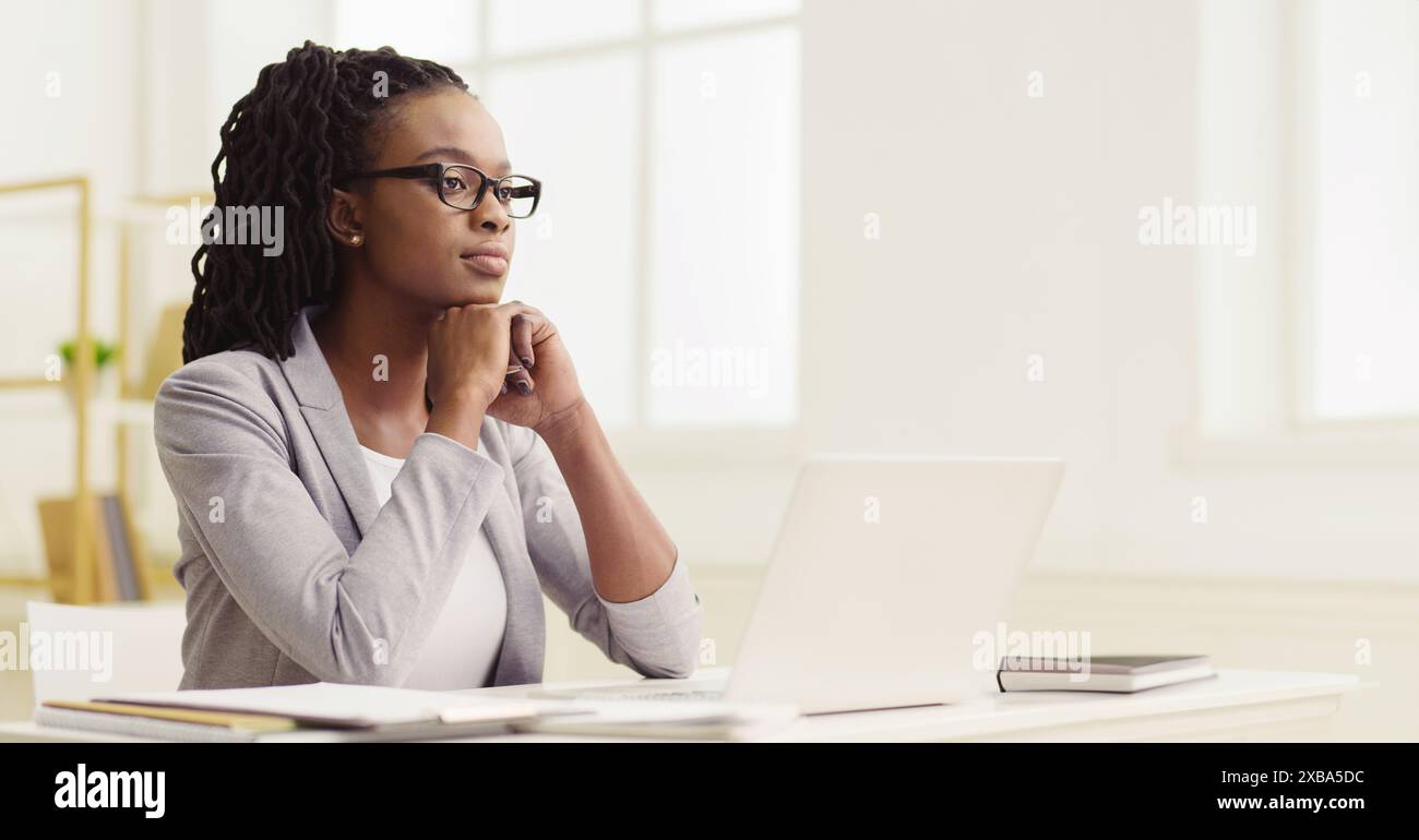 Pensive woman employee using computer in office Stock Photo - Alamy
