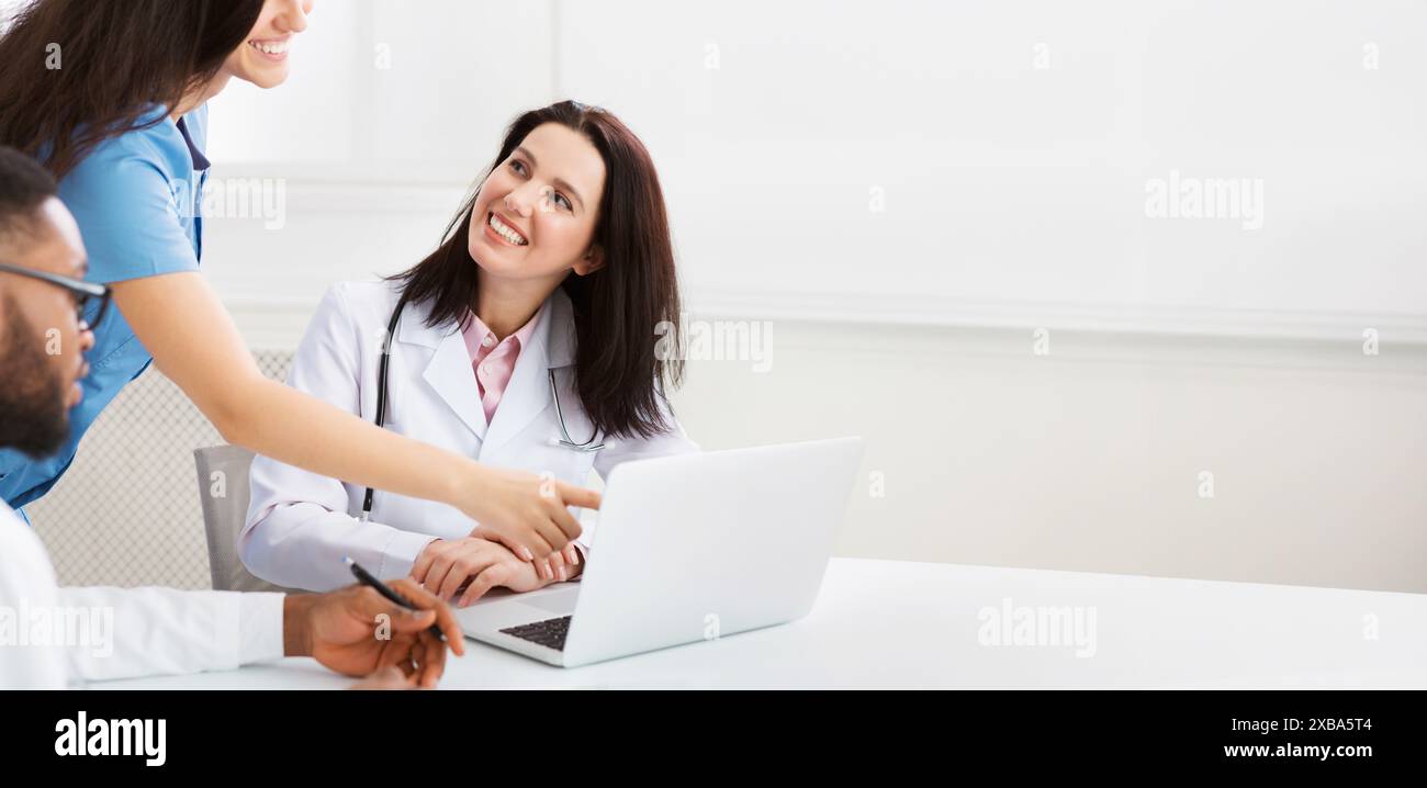 Medical Meeting. Successful Doctors Using Laptop In Hospital Stock ...
