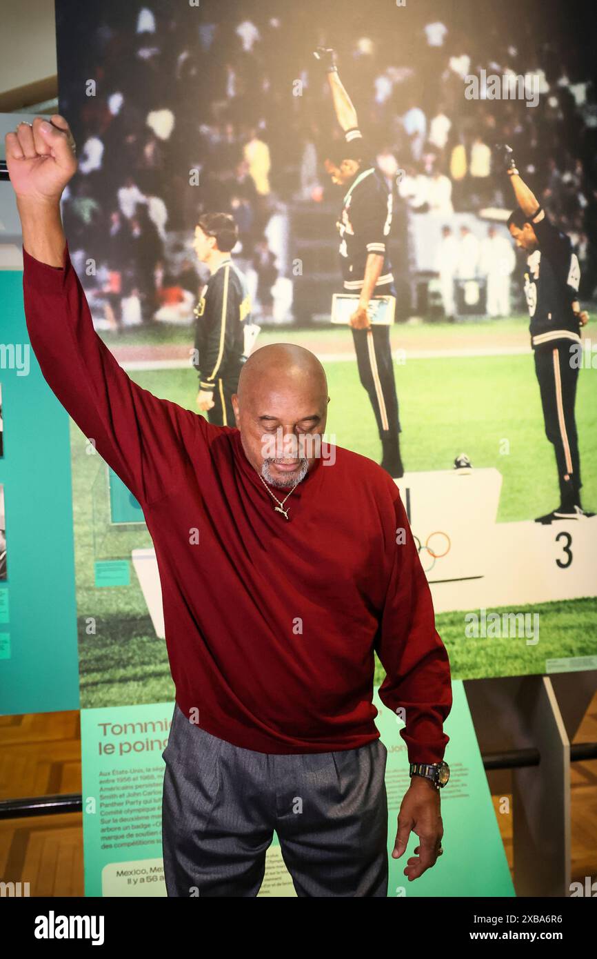 American former track and field athlete Tommie Smith reenacts his ...