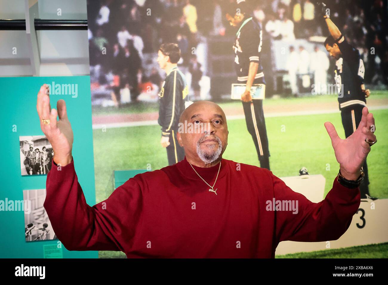 American former track and field athlete Tommie Smith gestures in front ...
