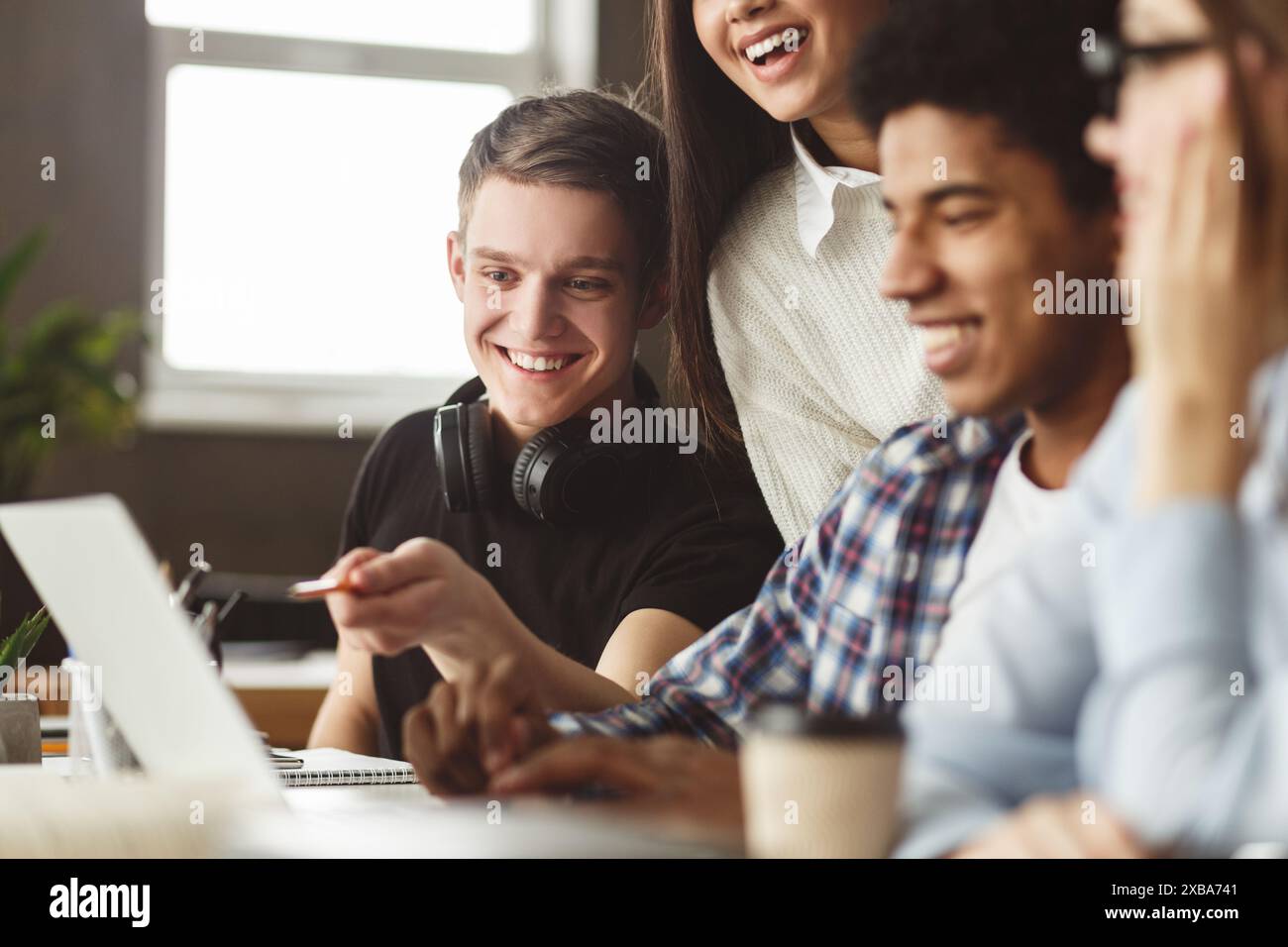 International students looking at laptop in school Stock Photo - Alamy