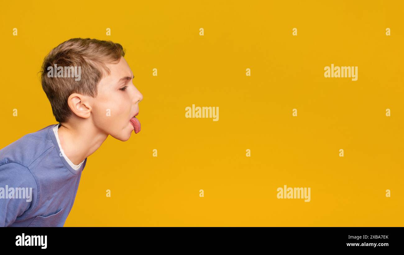 Little boy teasing someone, showing tongue and making face Stock Photo ...
