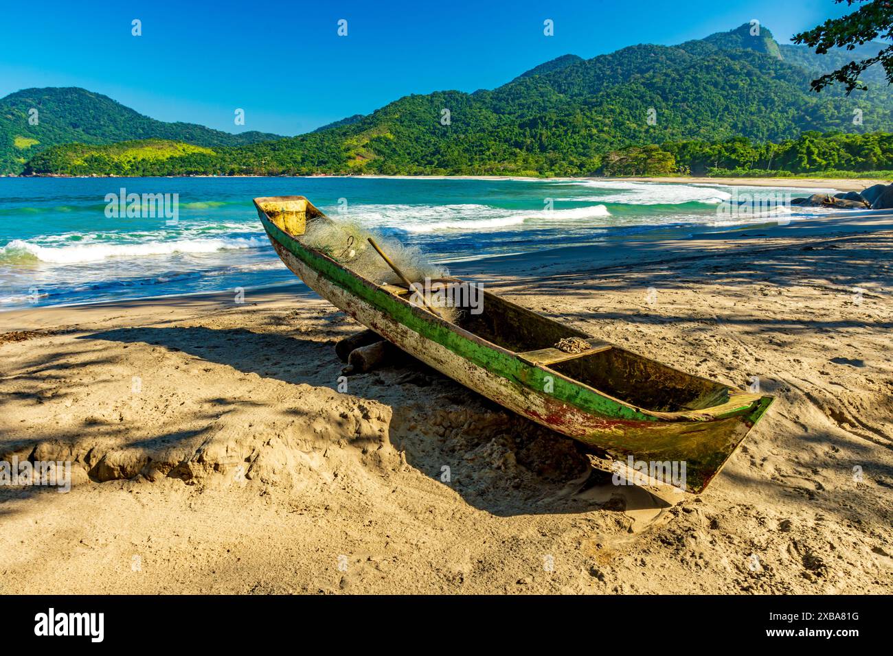 Primitive wooden fishing canoe on the sands of Castelhanos beach in ...