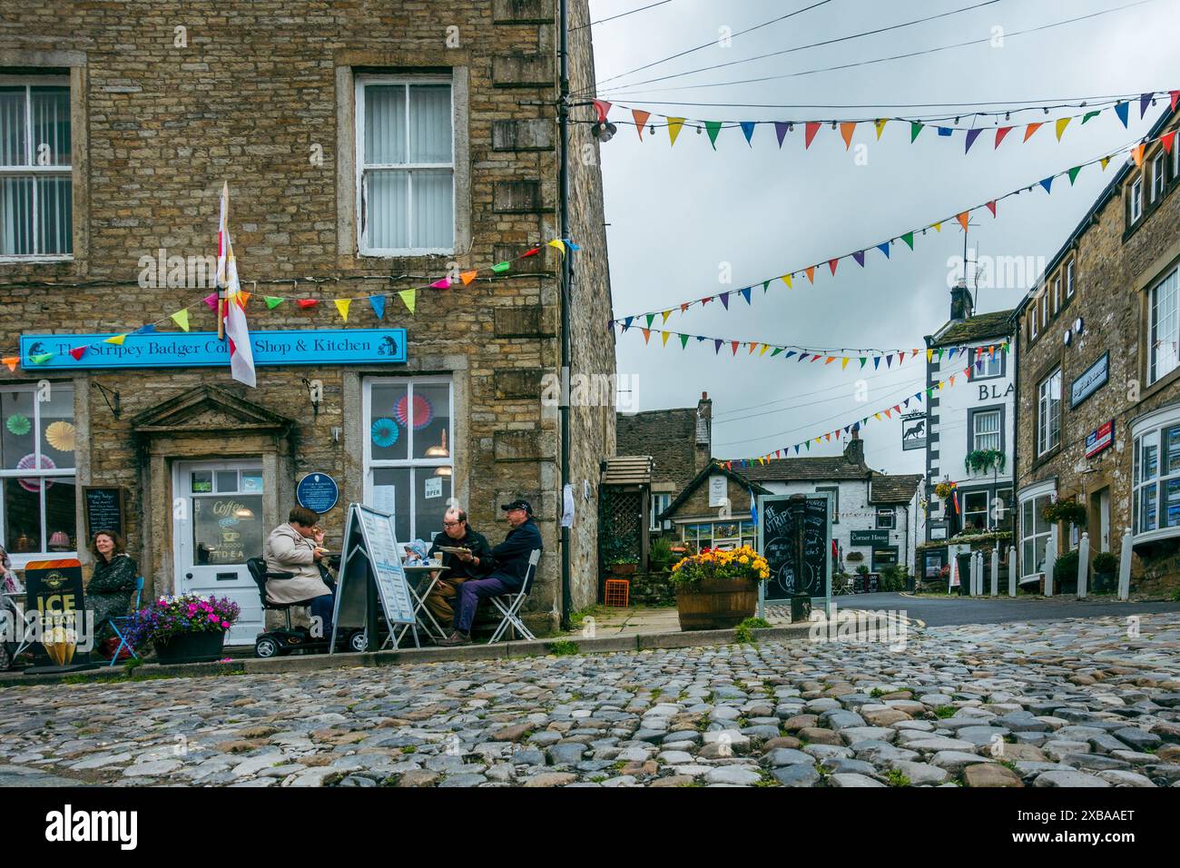 People sitting outside the Stripey Badger coffee shop in Grassington ...