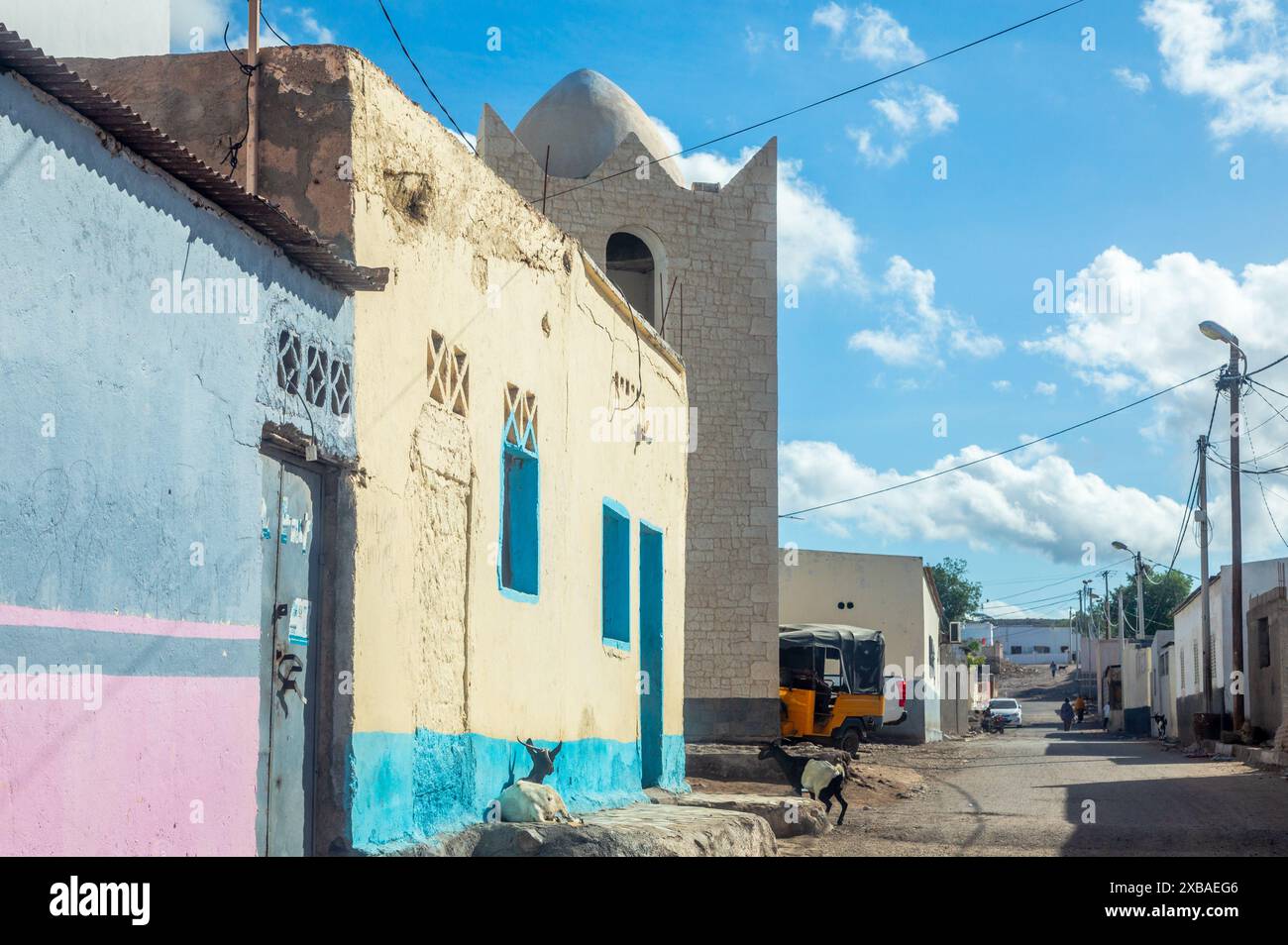 White mosque on the street of Tajoura with goats at the entrance ...