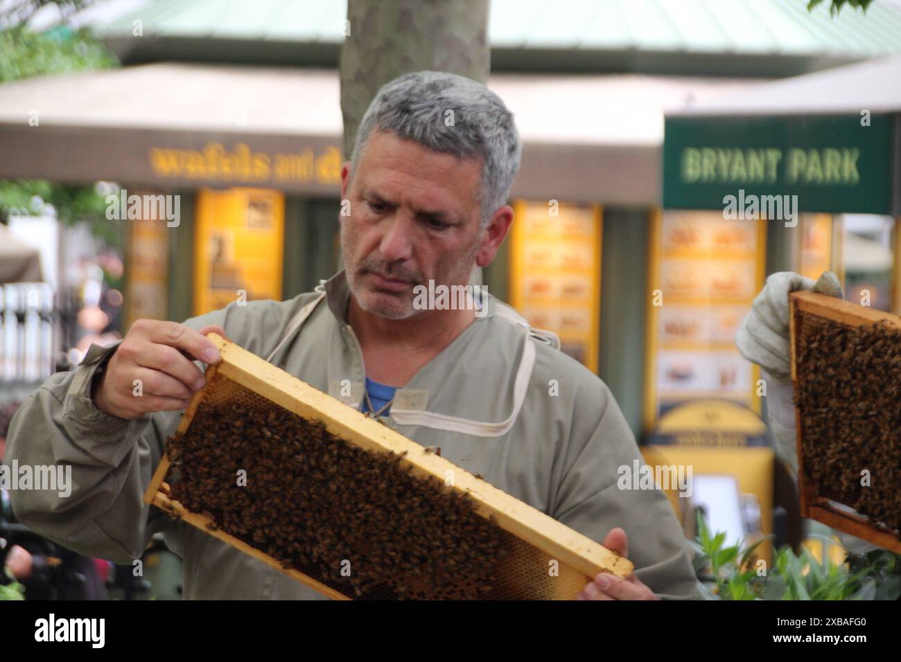 New York, USA. 17th May, 2024. Beekeeper Andrew Coté checks the hives ...