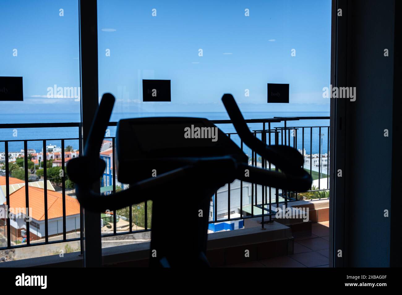 Handlebars of a stationary bicycle looking through a glass window at ...
