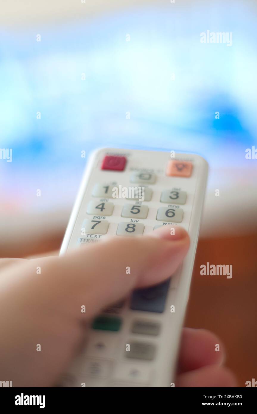 Hand with Remote Control Stock Photo - Alamy
