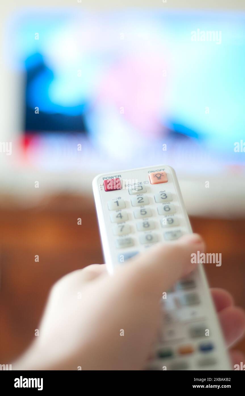 Hand with Remote Control Stock Photo - Alamy