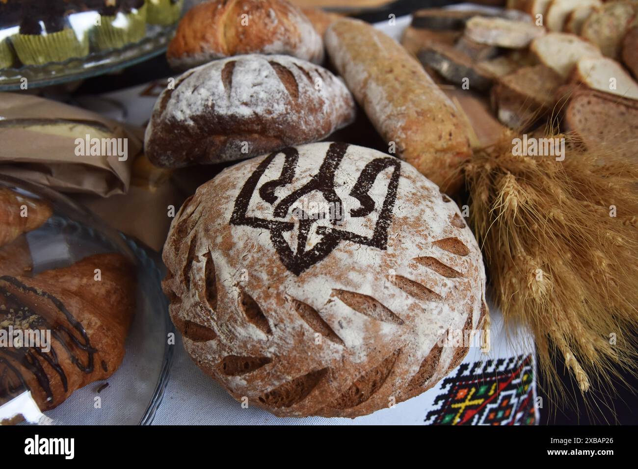 Lviv, Ukraine. 08th June, 2024. View of a bread with the coat of arms ...