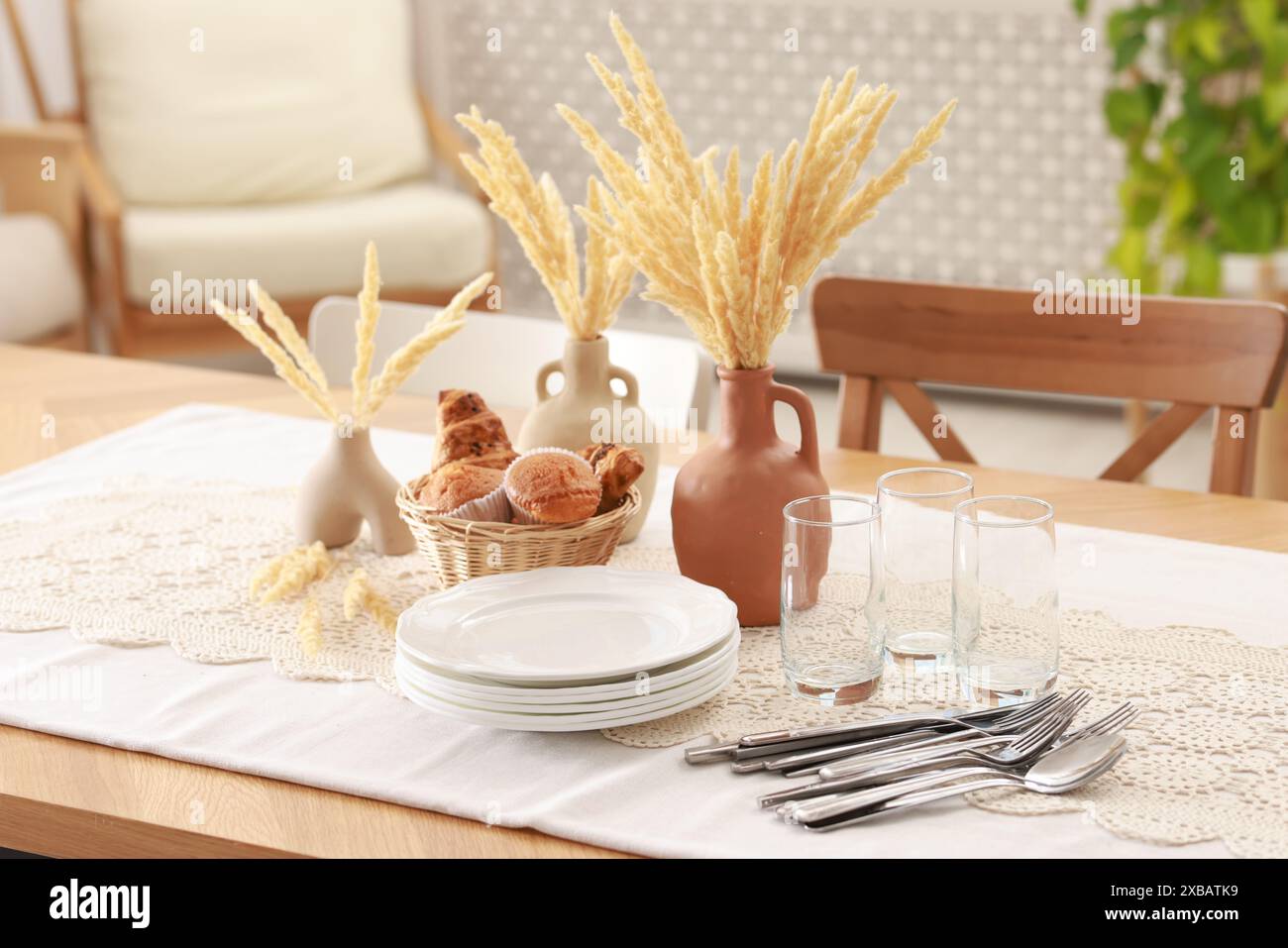 Clean dishes, dry spikes and fresh pastries on table in stylish dining ...