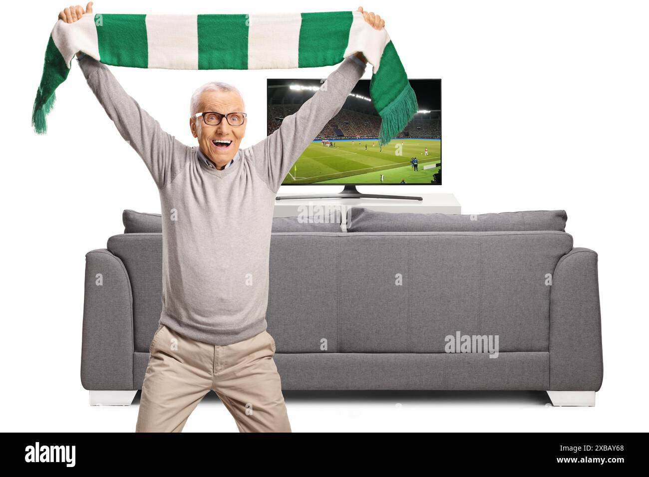 Happy senior man cheering with a scarf in front of a tv screen with a ...