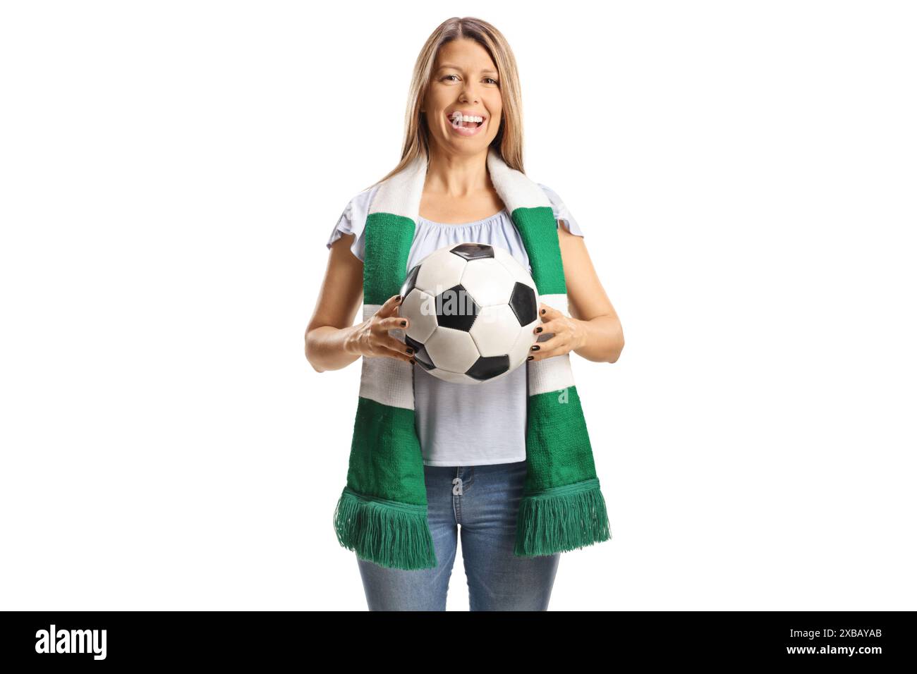 Female sports fan with scarf around her neck holding a football and ...