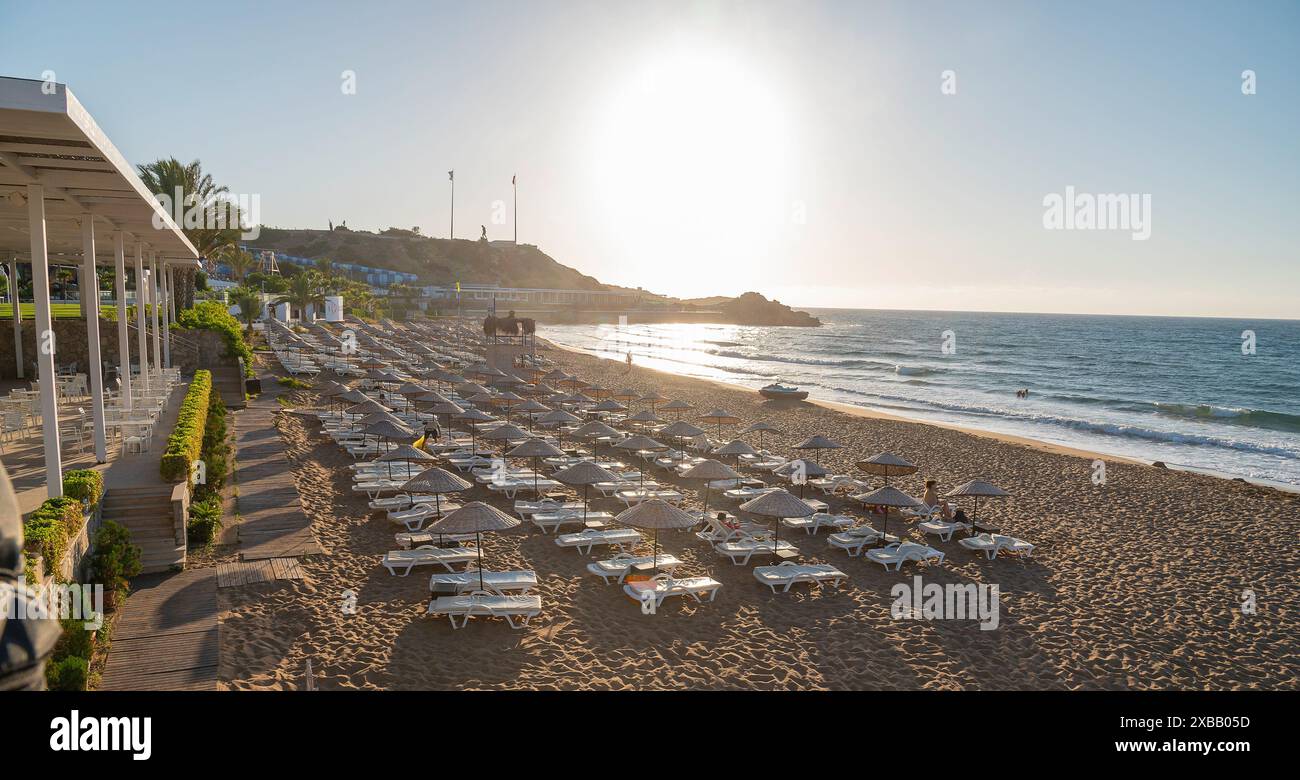 Catalkoy, Kyrenia, Northern Cyprus- June 1, 2024 Empty sun loungers on the beach in evening time ...