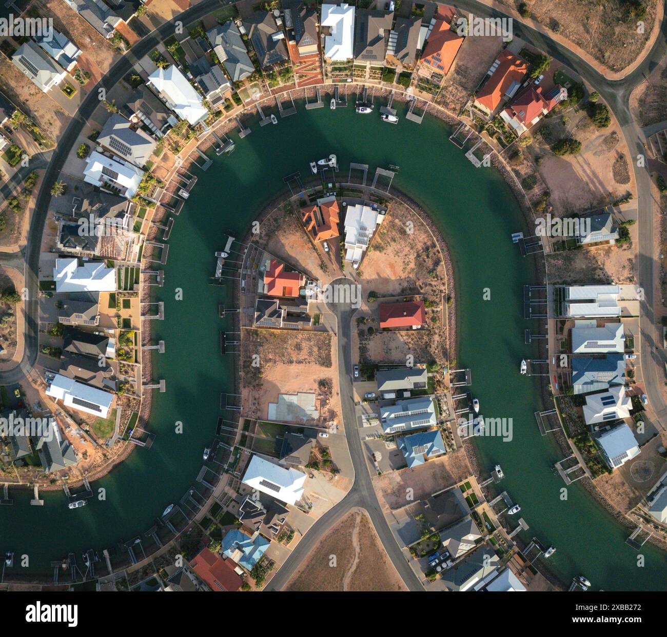 Aerial view of a residential neighborhood with houses and boats along a ...