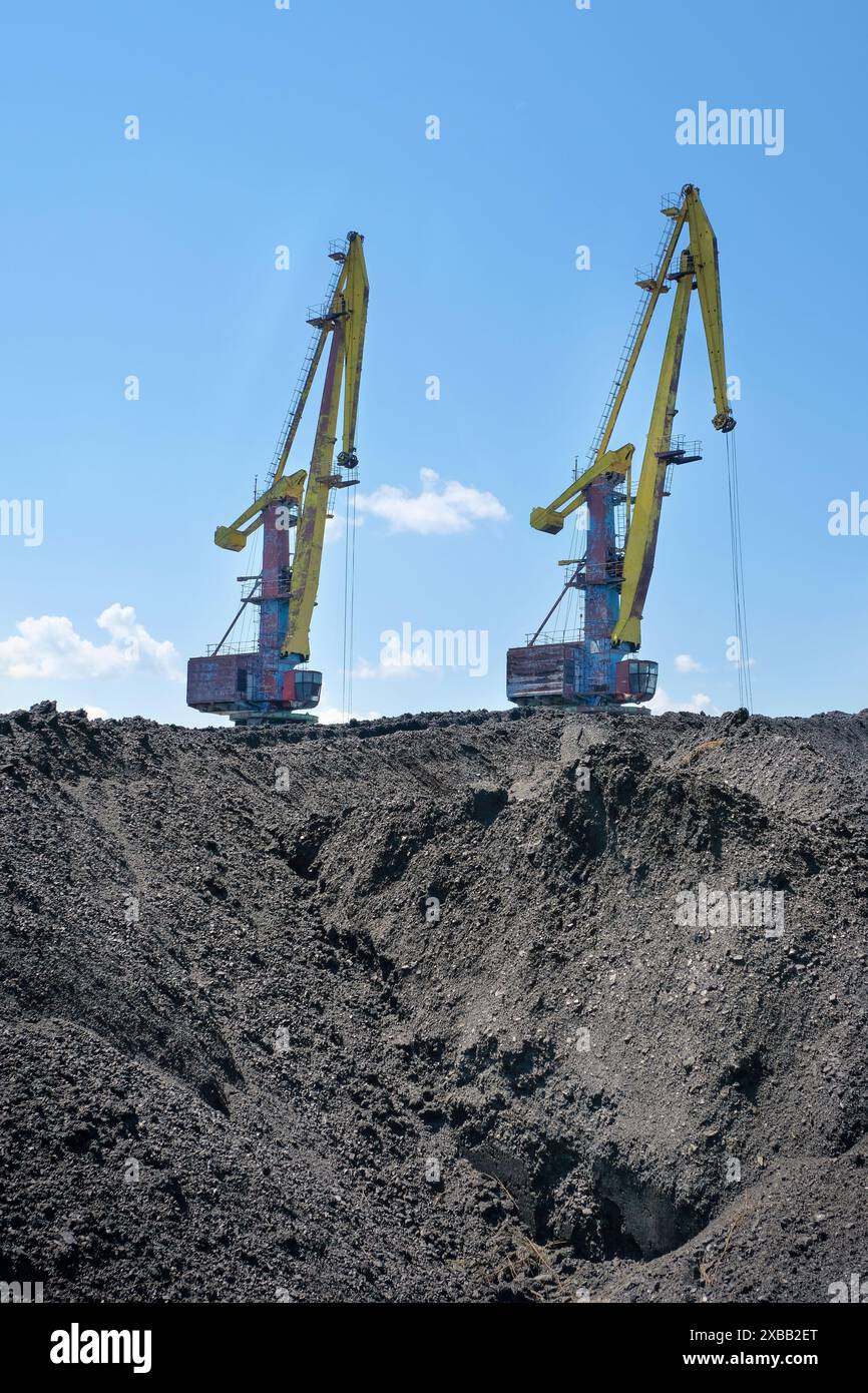 Coal mining and storage. Close-up of coal industry objects. Piles of ...