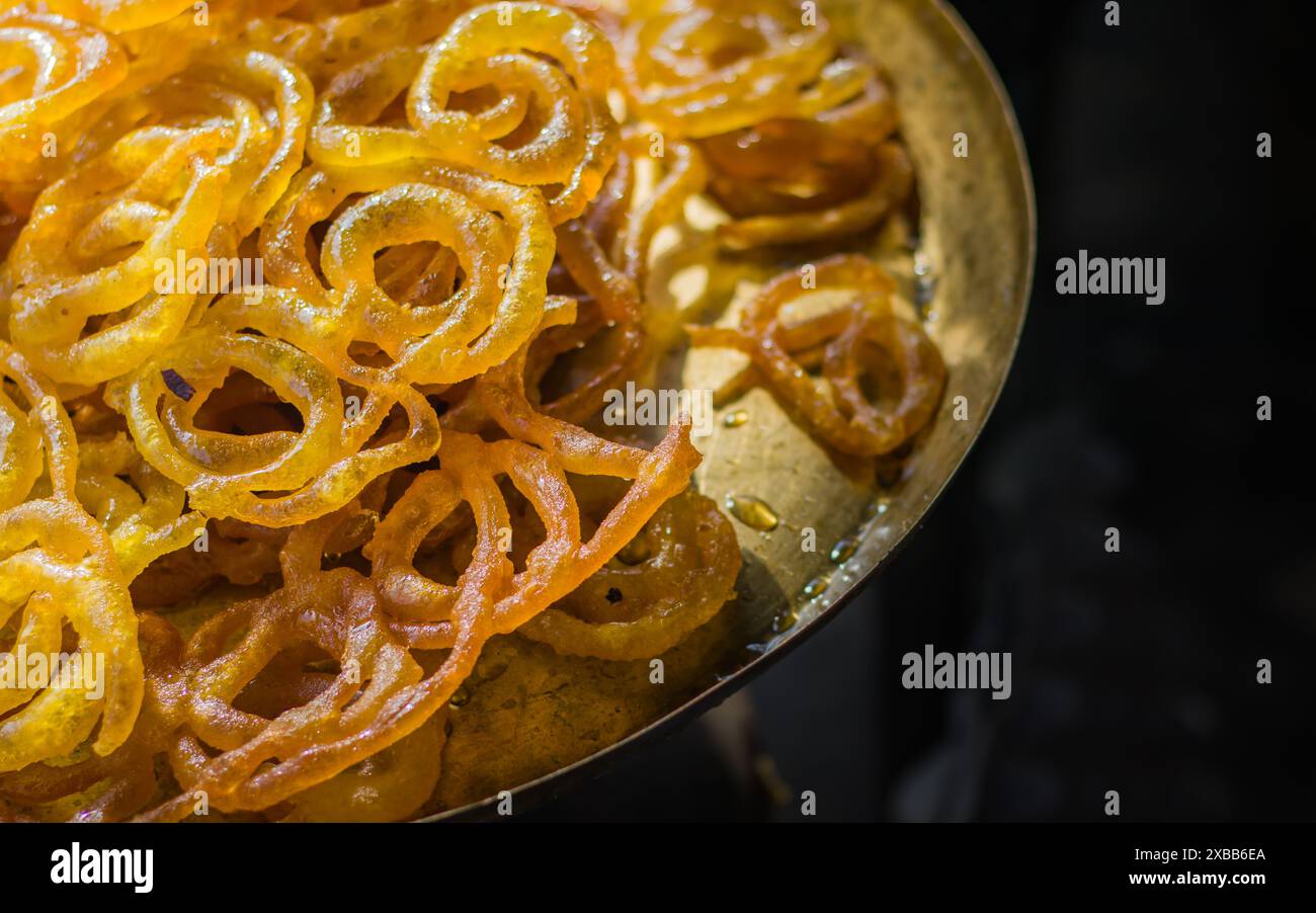 Jalebi or jilipi, freshly cooked and kept on tray for hindu festival of ...