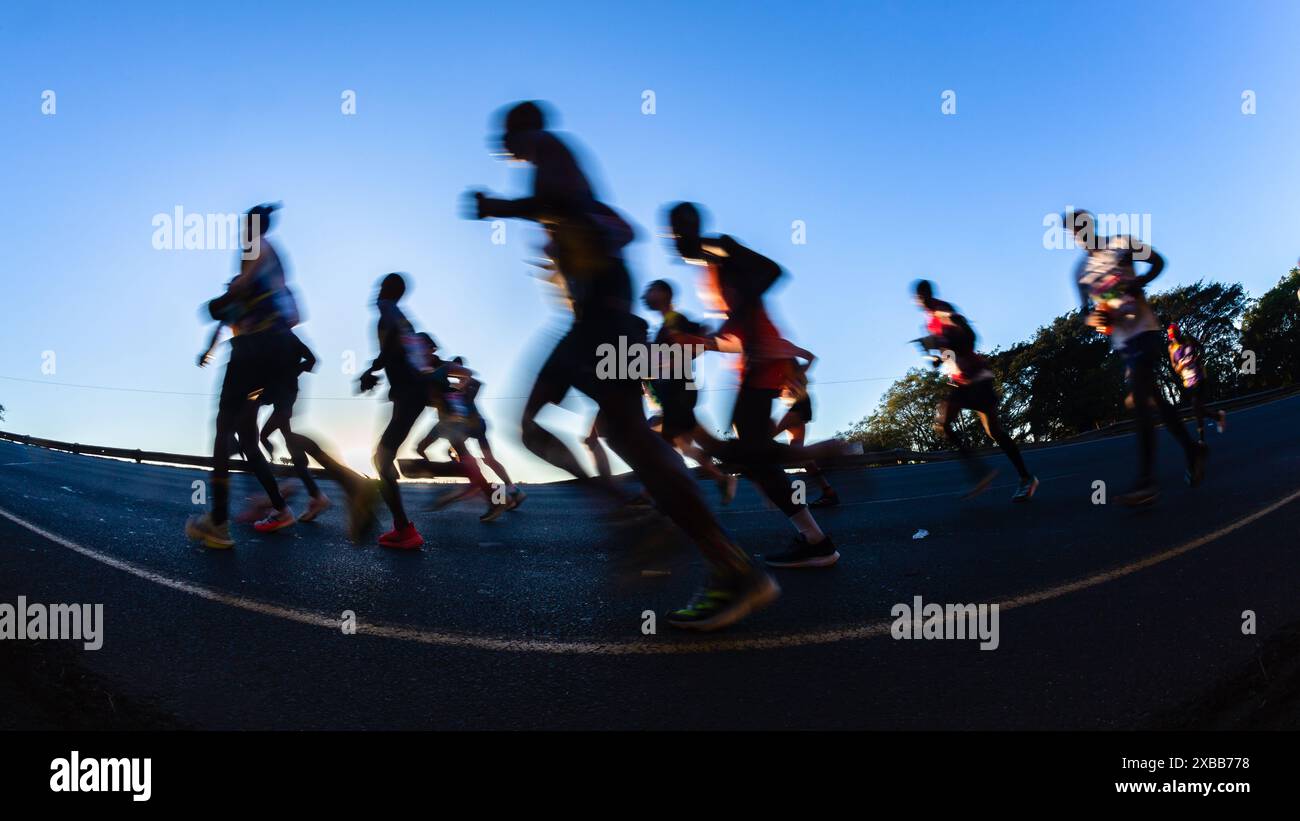 Marathon runners motion speed blurs silhouetted morning dawn sunrise ...