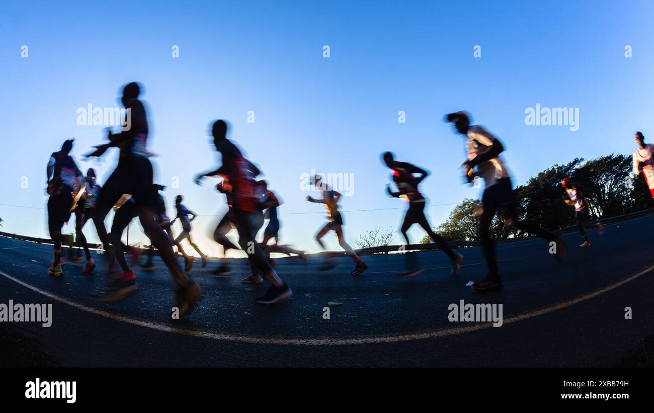 Marathon runners motion speed blurs silhouetted morning dawn sunrise ...